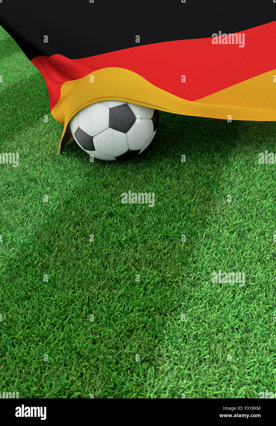 Soccer ball and national flag of Germany lies on the green grass Stock ...