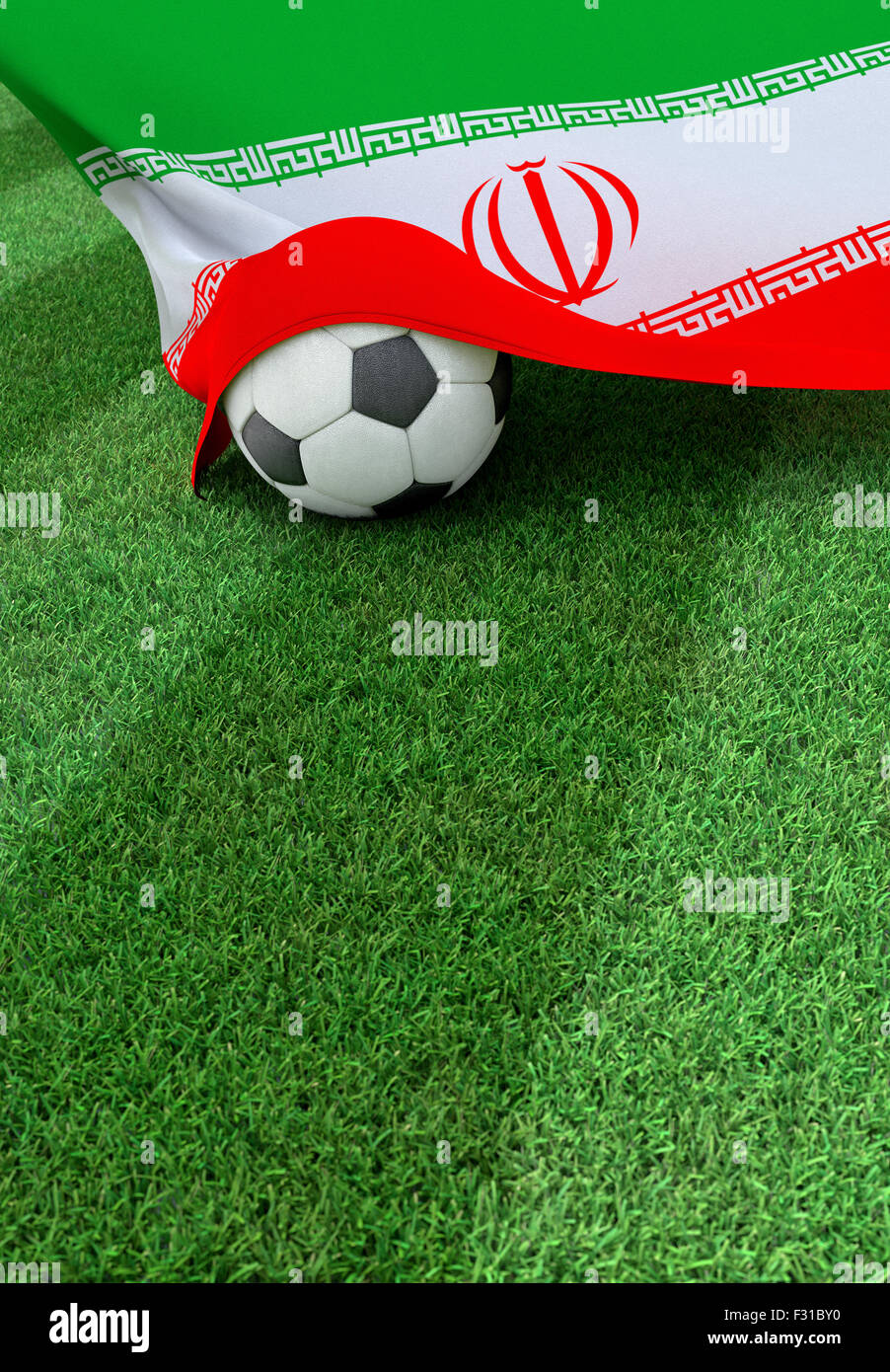 Soccer ball and national flag of Iran lies on the green grass Stock ...