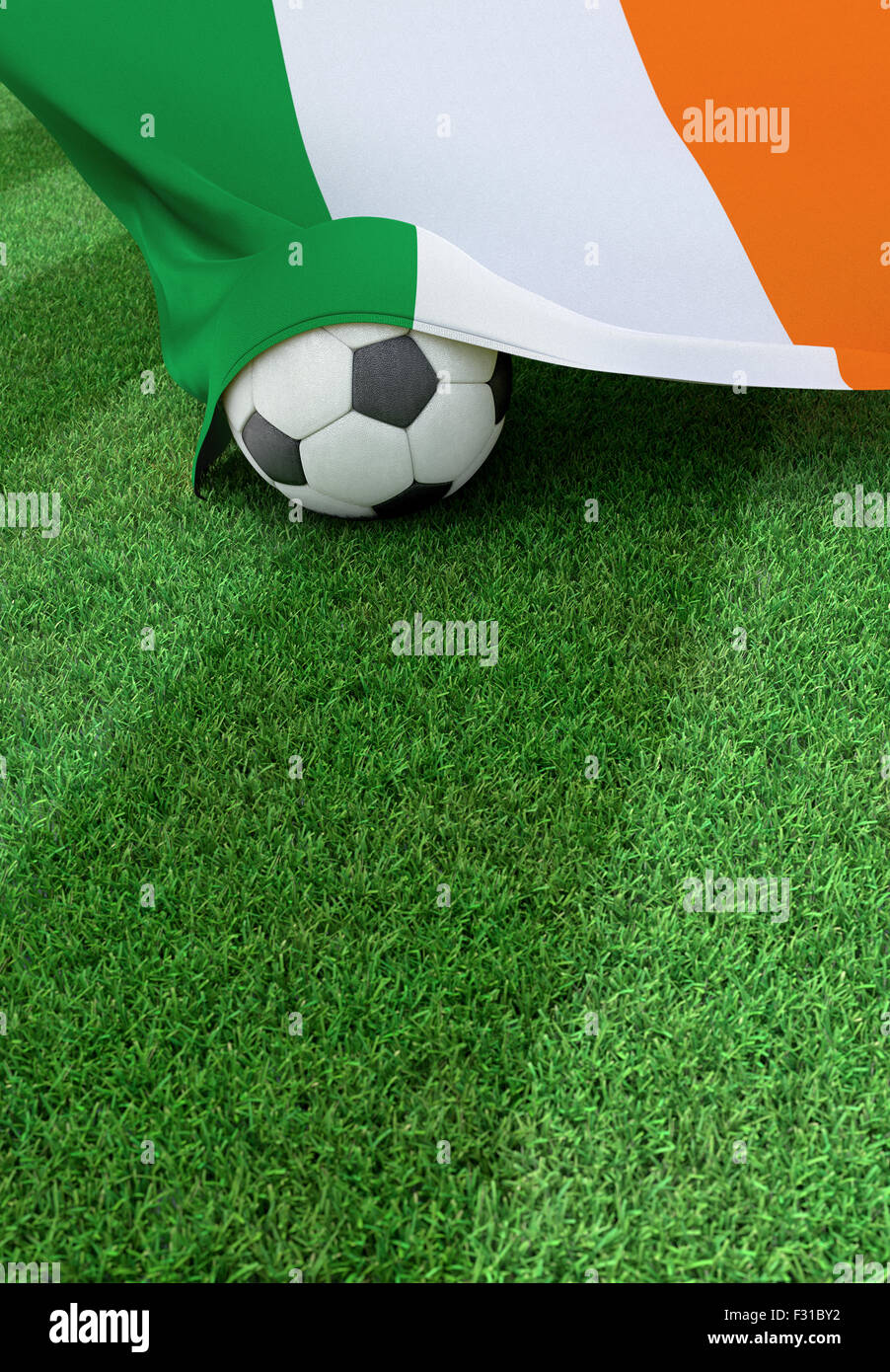 Soccer ball and national flag of Ireland lies on the green grass Stock ...