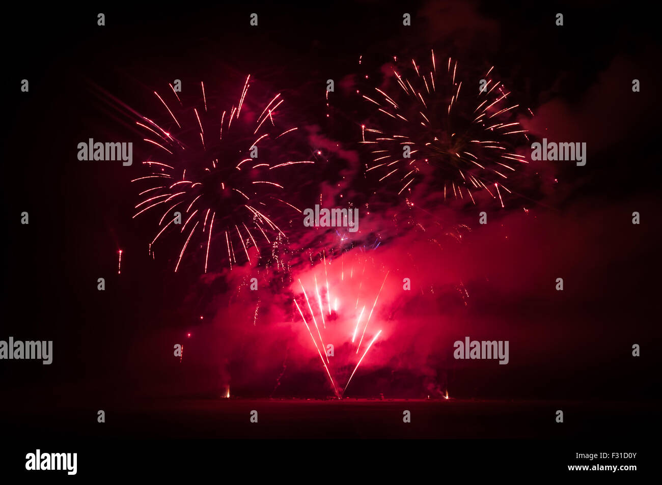 Beautiful red fireworks on the night sky Stock Photo - Alamy