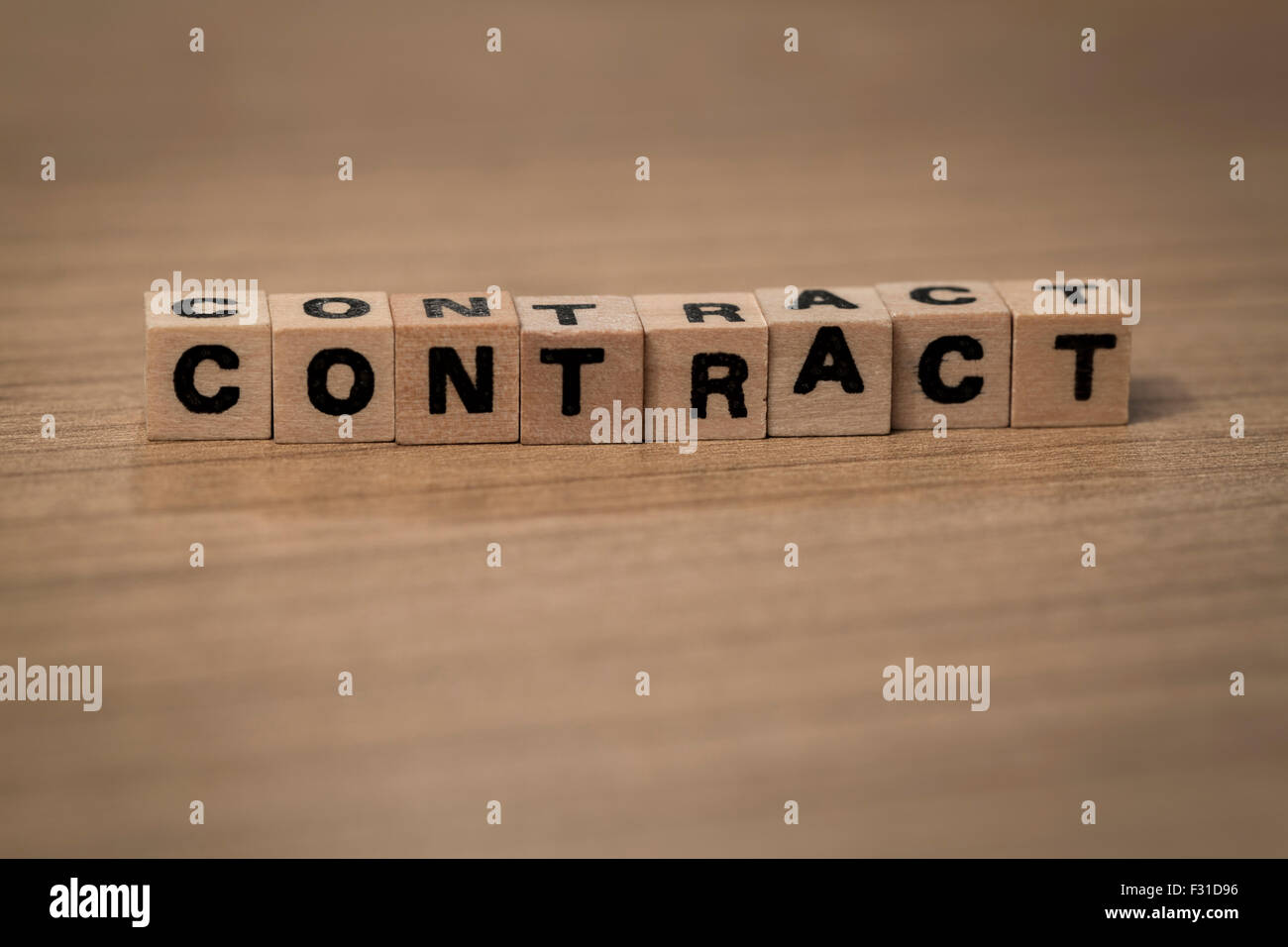 Contract written in wooden cubes on a desk Stock Photo - Alamy