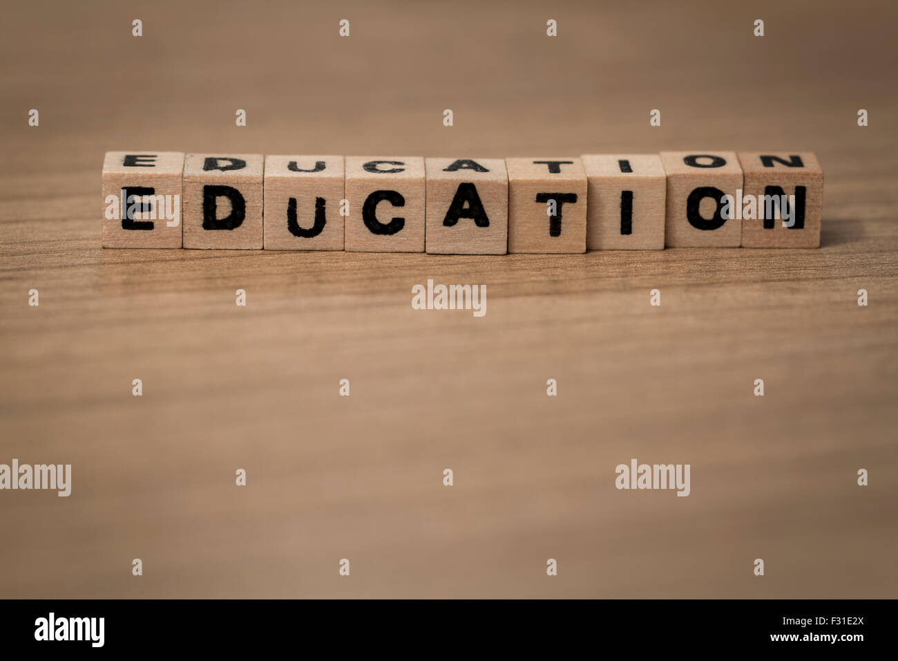 Education written in wooden cubes on a desk Stock Photo - Alamy
