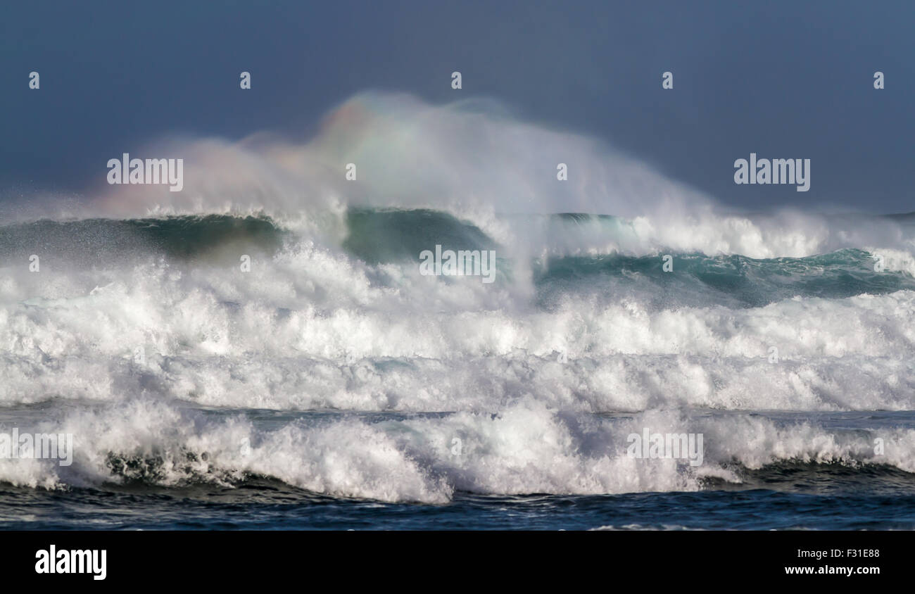 Breaking Ocean waves and rainbow colors in the spray back Stock Photo ...