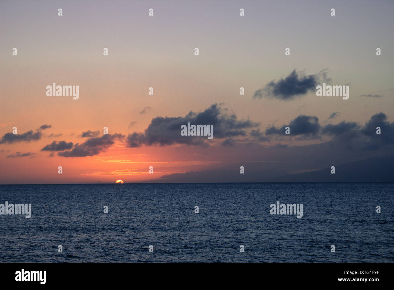 The sun sets over the Pacific Ocean seen from Maui, Hawaii Stock Photo ...