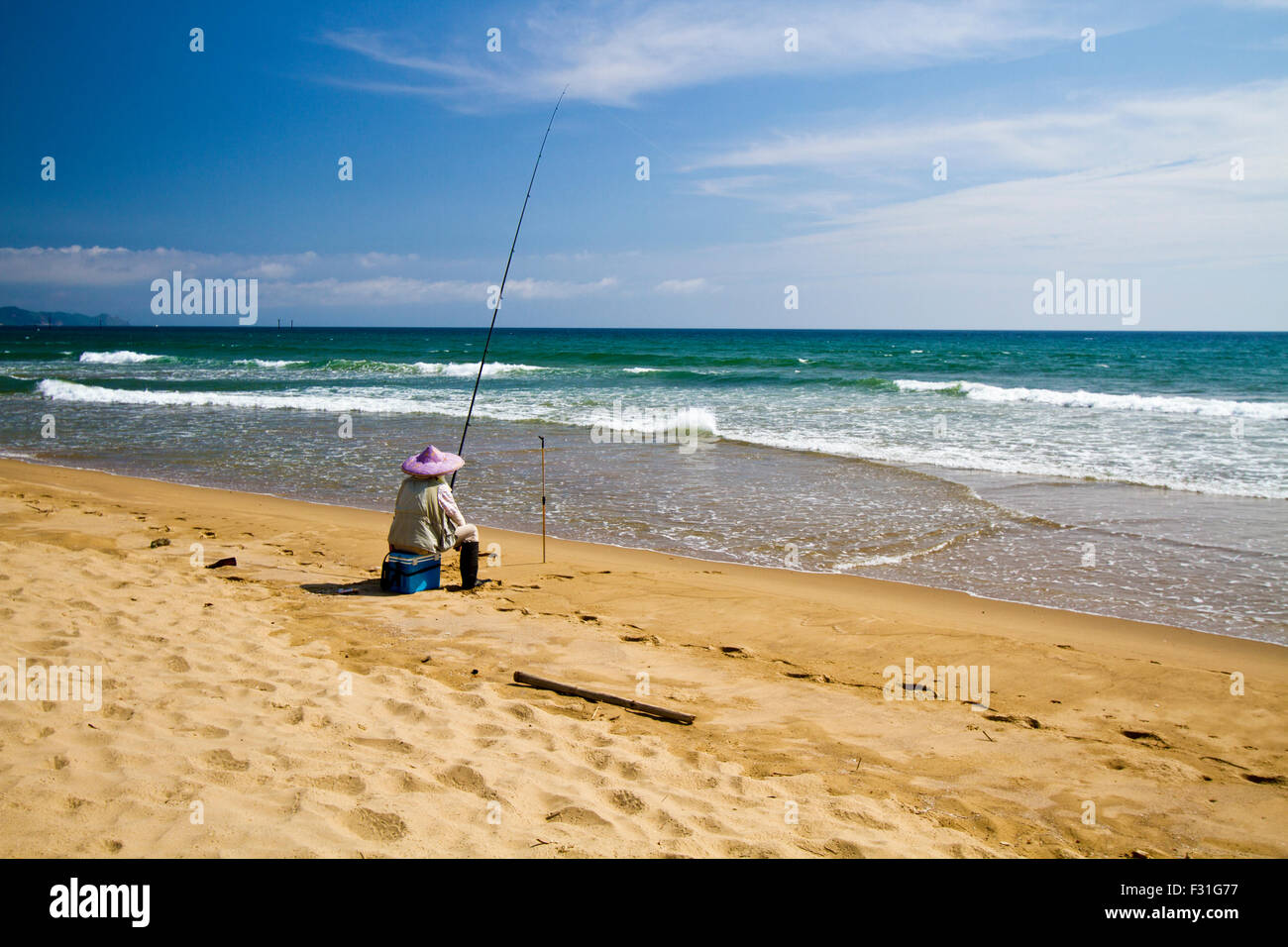 fish man fishing on the beach under sunbath Stock Photo - Alamy
