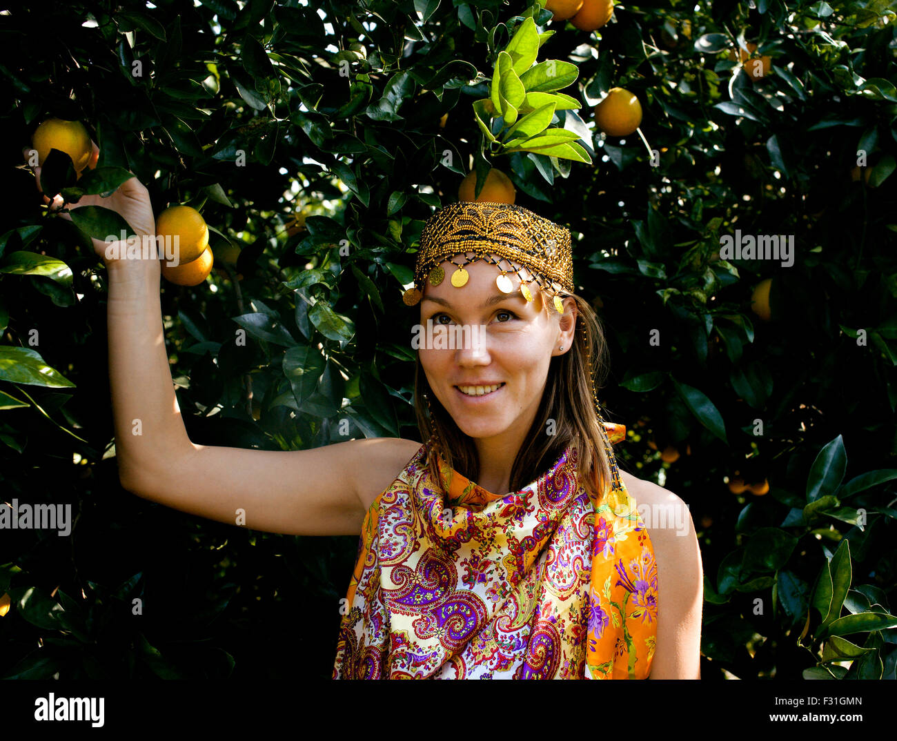 pretty islam woman in orange grove smiling, real muslim girl Stock ...