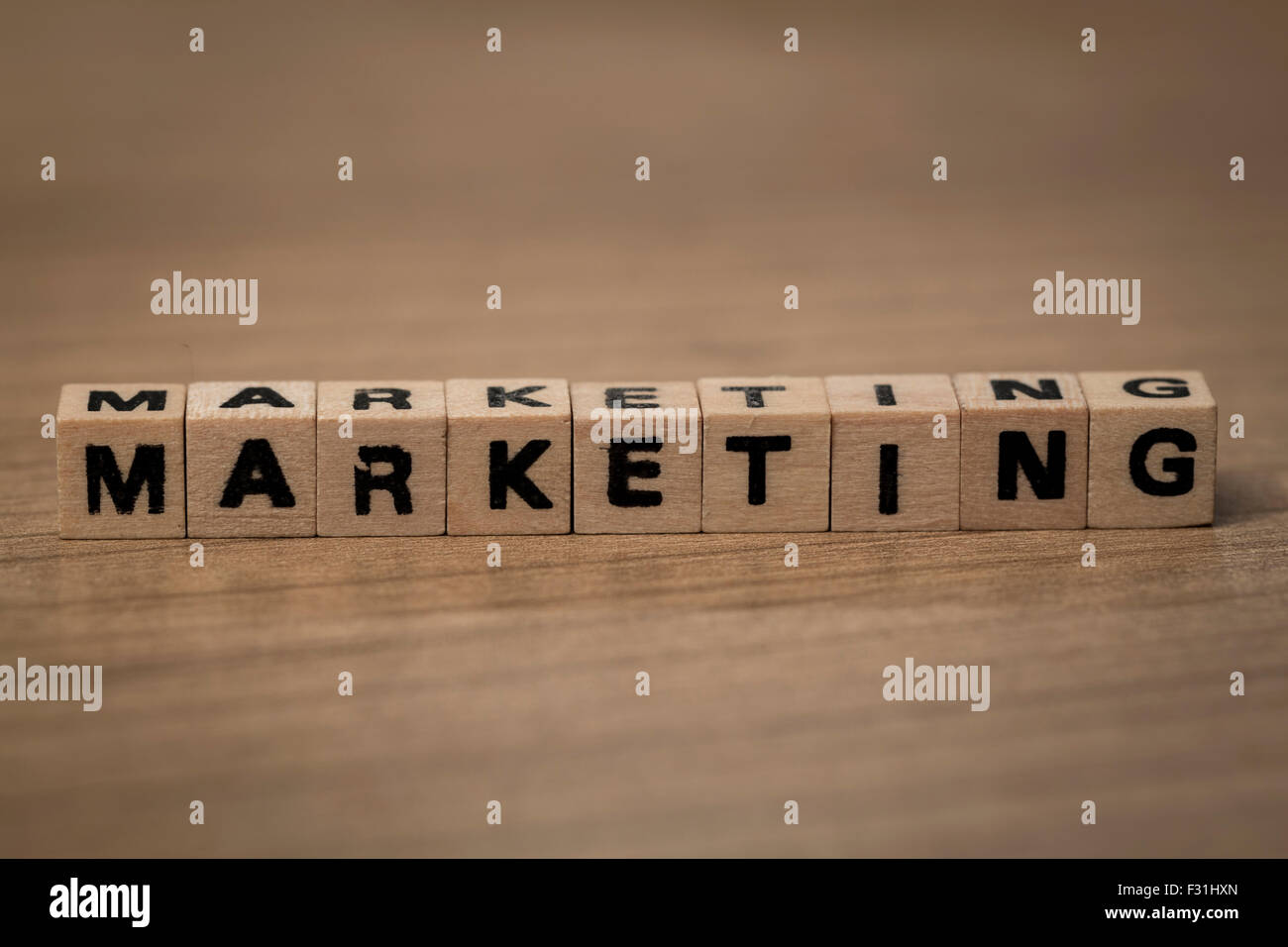 marketing written in wooden cubes on a desk Stock Photo - Alamy