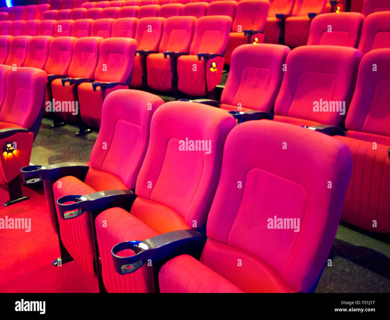 Red seats of cinema hall after the movie Stock Photo - Alamy