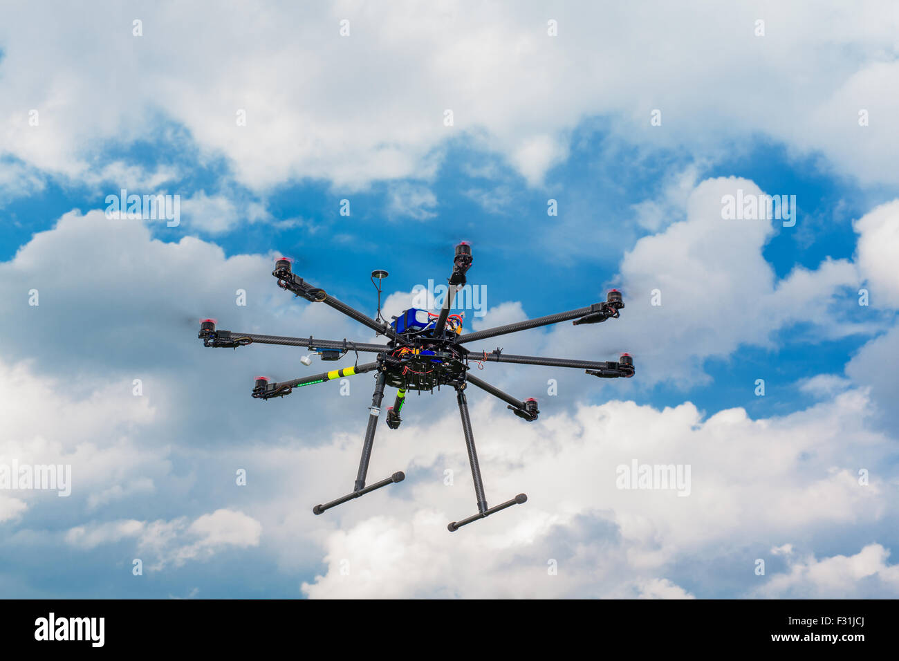 Multicopter in flight on sky and clouds background Stock Photo - Alamy