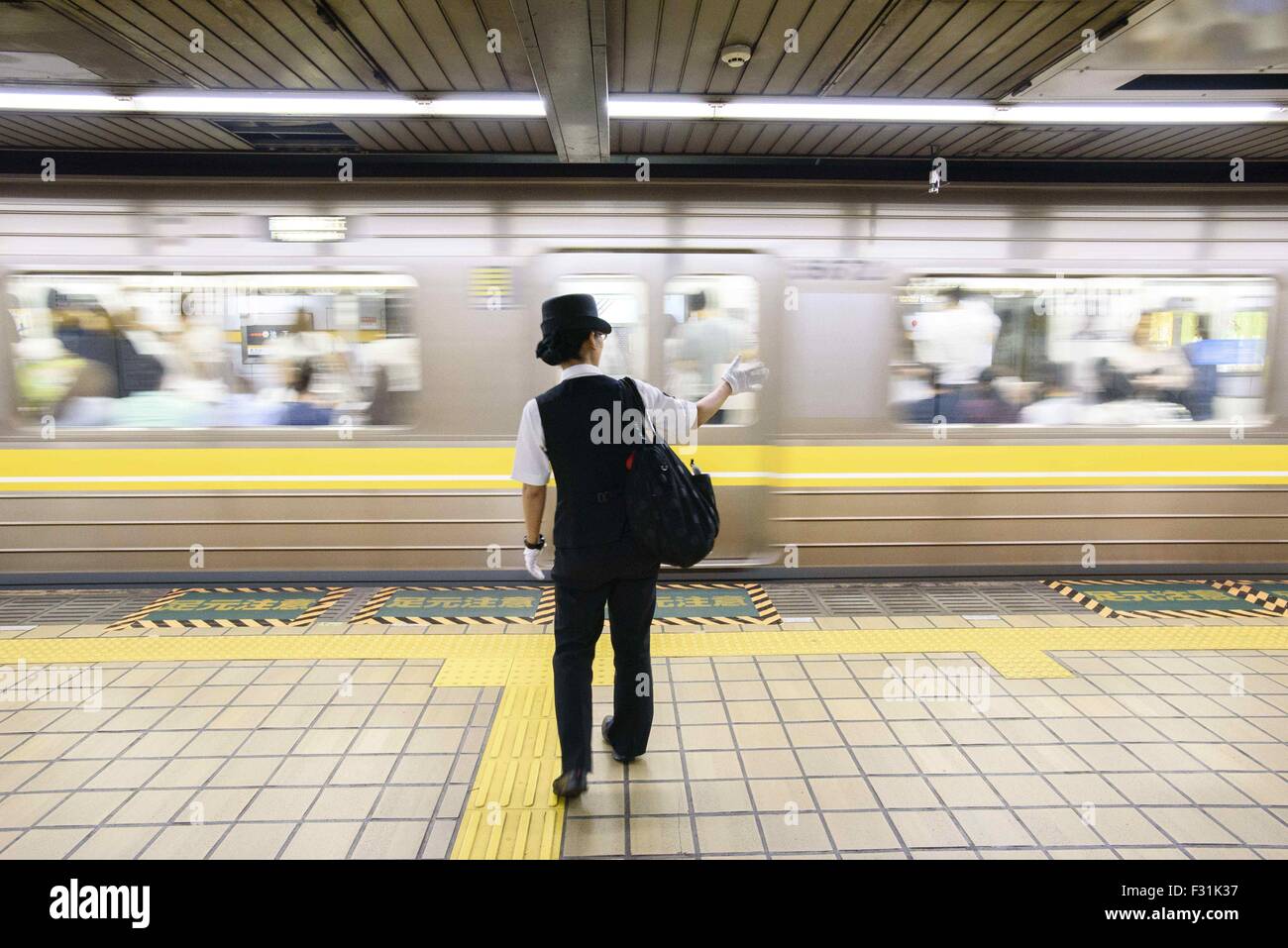 Nagoya, Aichi, Japan. 28th Sep, 2015. A train conductor signals a clear ...
