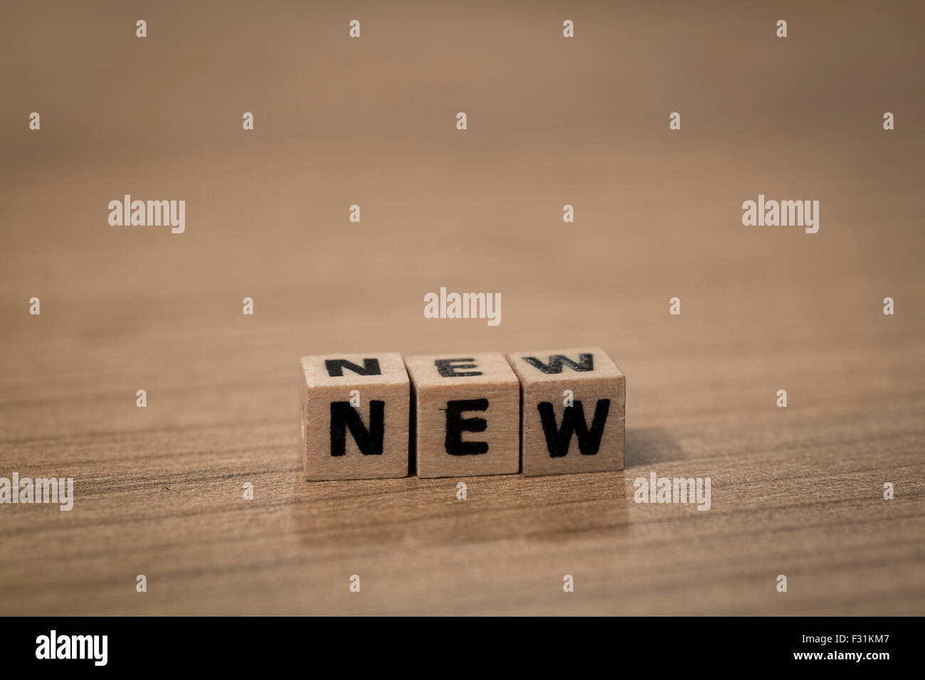 New written in wooden cubes on a desk Stock Photo - Alamy