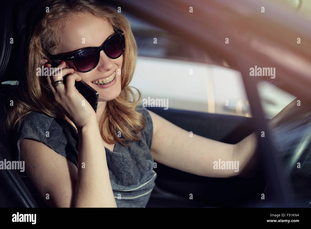 Woman talking on the phone in the car Stock Photo - Alamy
