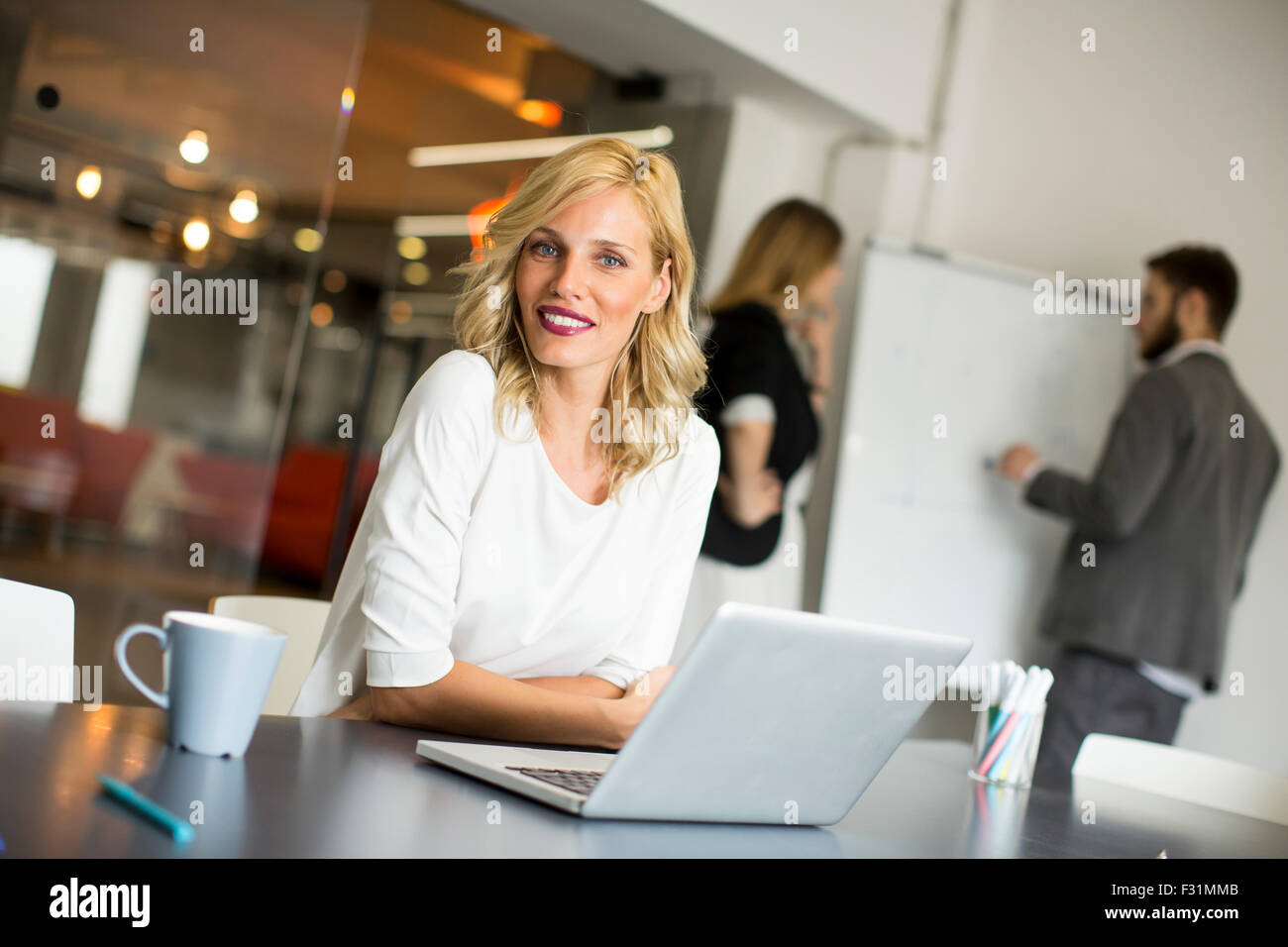 Young people in the office Stock Photo - Alamy