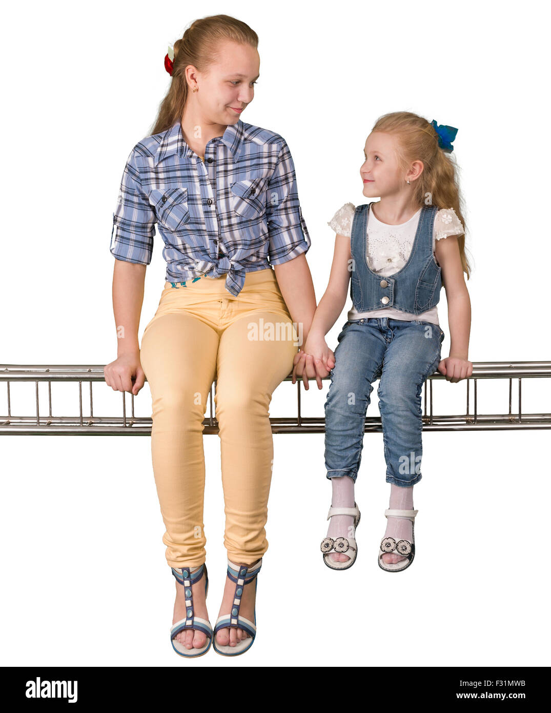 Two girls sitting on the beam on white background Stock Photo - Alamy
