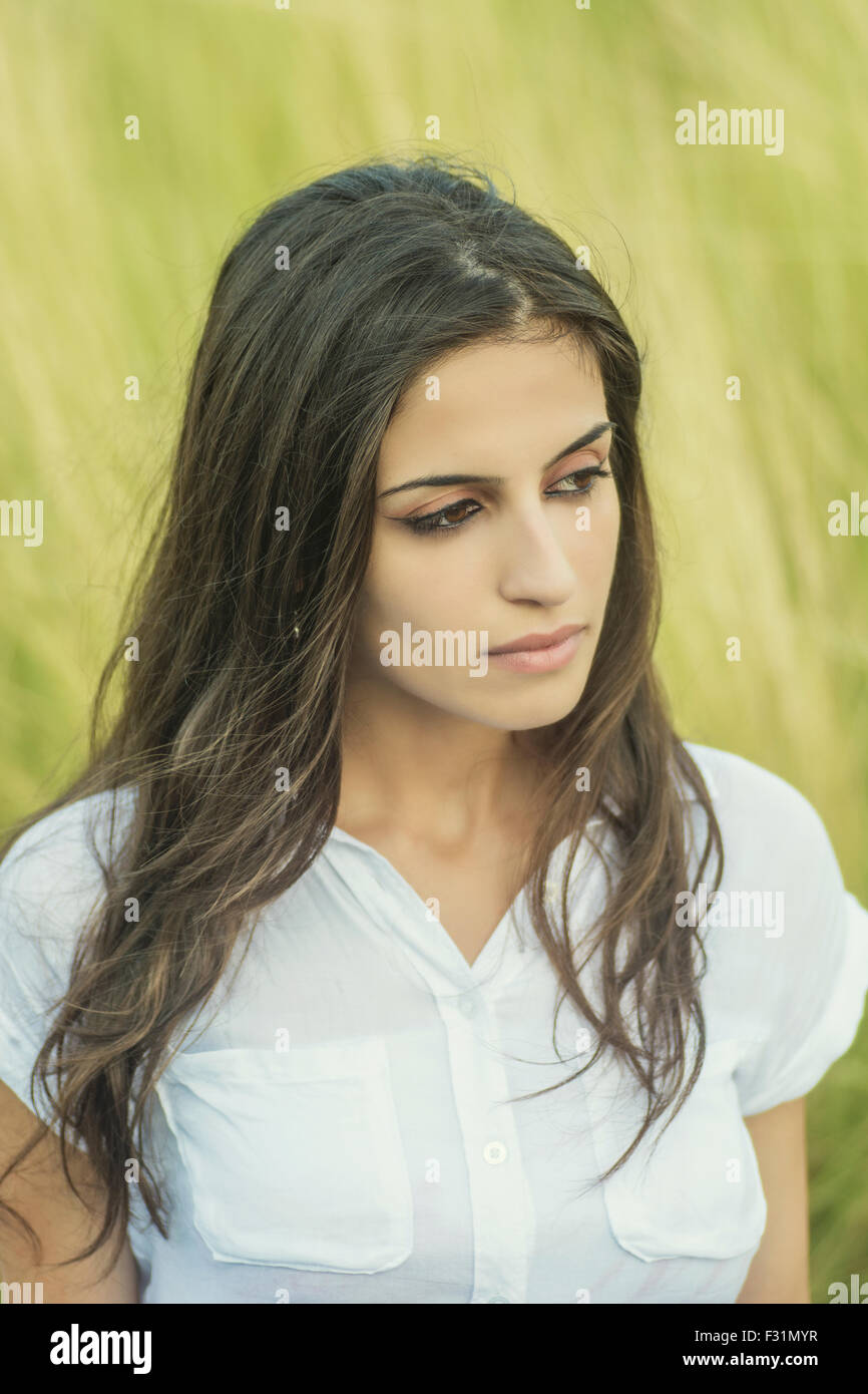 Serious young woman looking away outdoors Stock Photo - Alamy