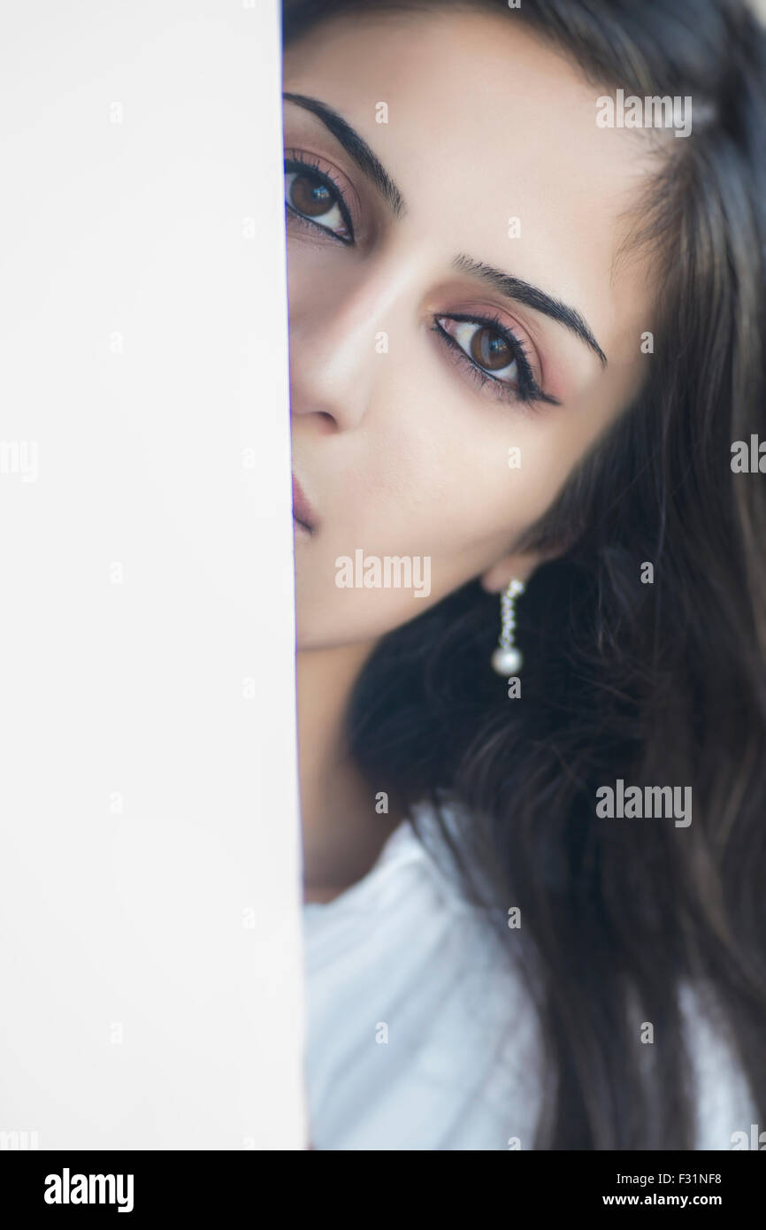 Hiding behind wall hi-res stock photography and images - Alamy