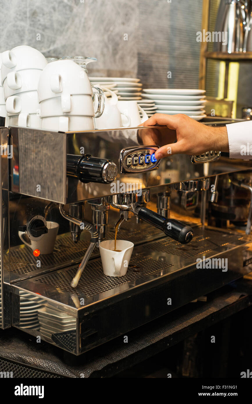 Barista working on espresso machine, pouring coffee Stock Photo - Alamy