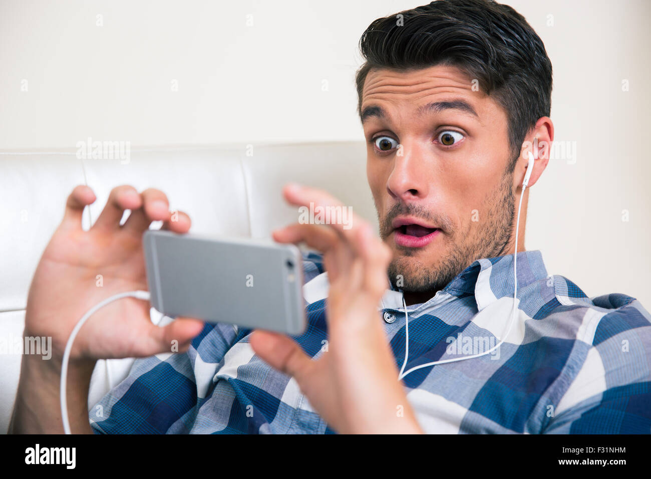 Portrait of a funny man gaming on smartphone at home Stock Photo - Alamy