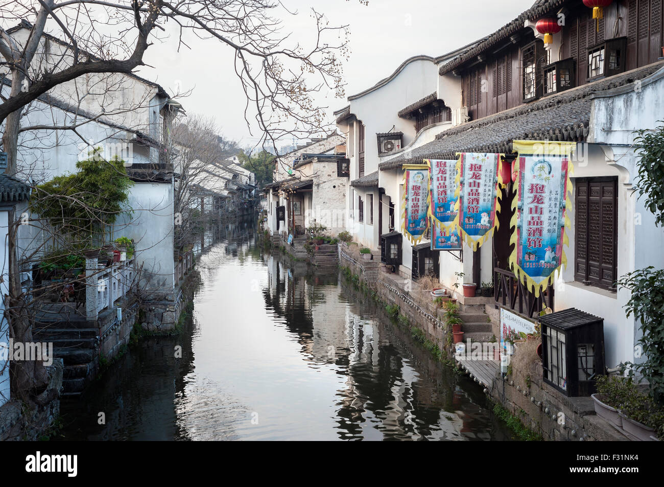 Traditional whitewashed buildings line a canal in the eastern Chinese ...
