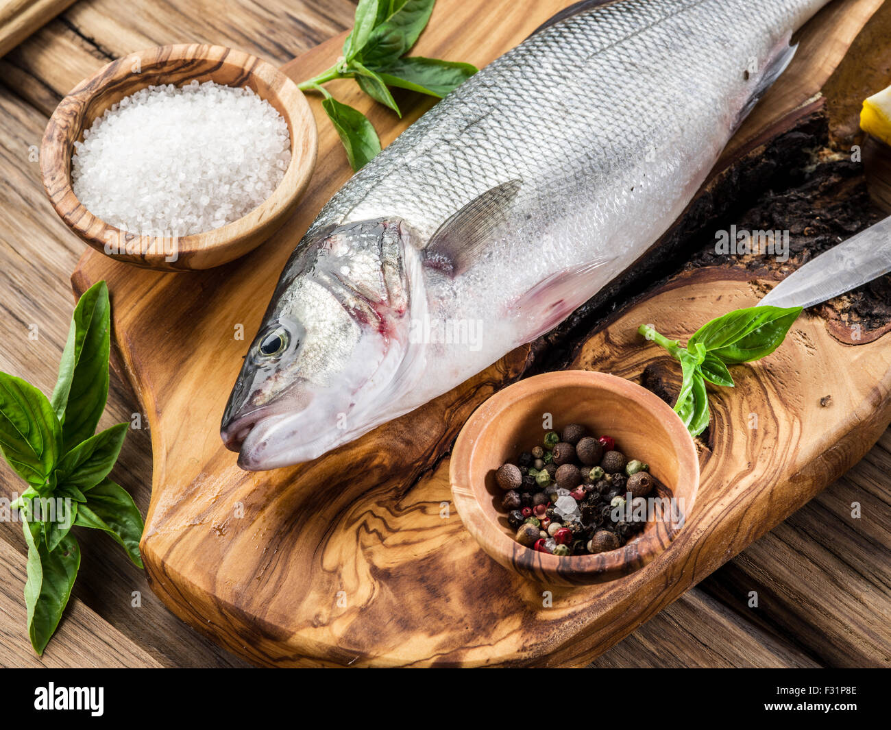 Sea bass fish on the graphite board Stock Photo - Alamy