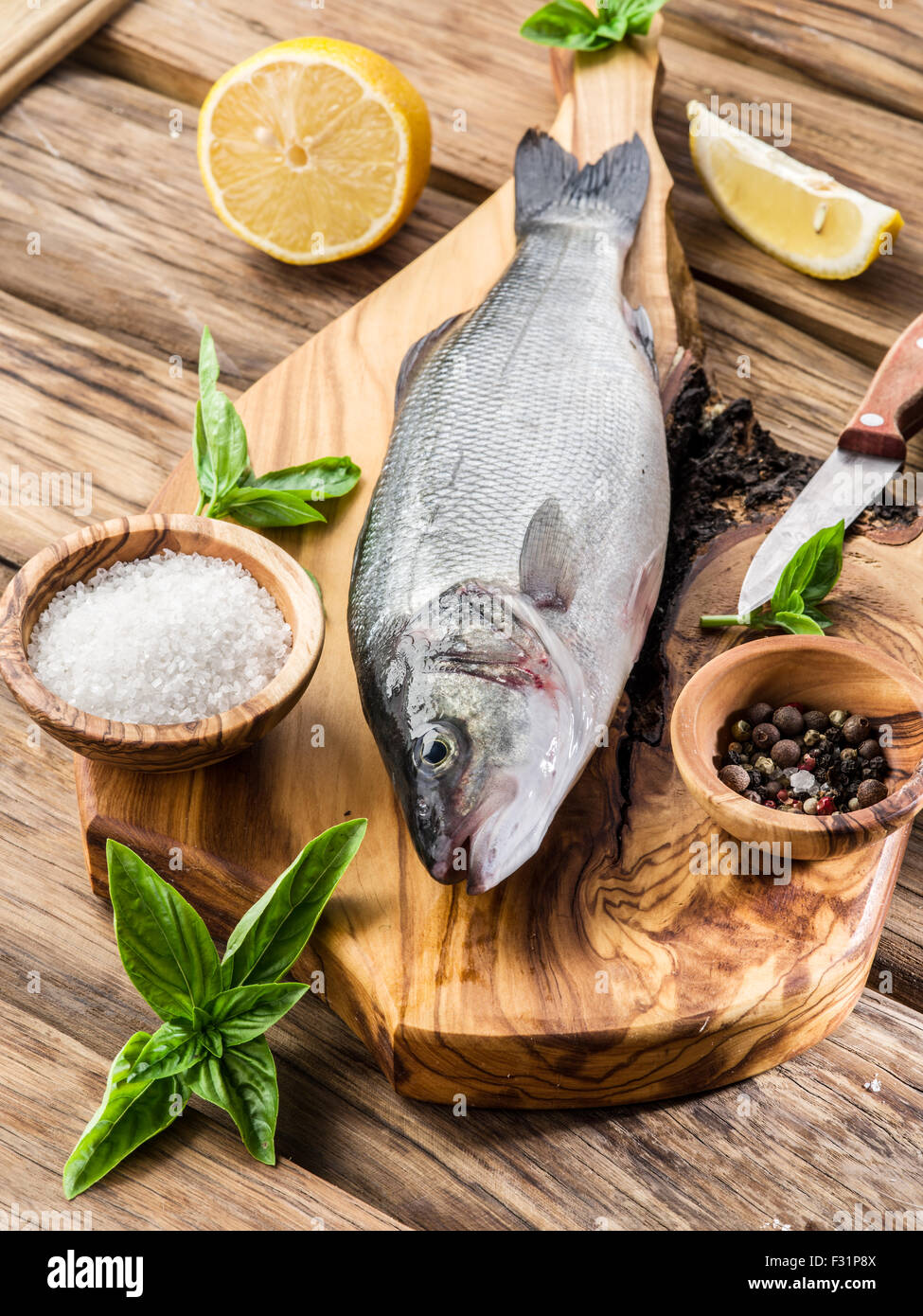 Sea bass fish on the graphite board Stock Photo - Alamy