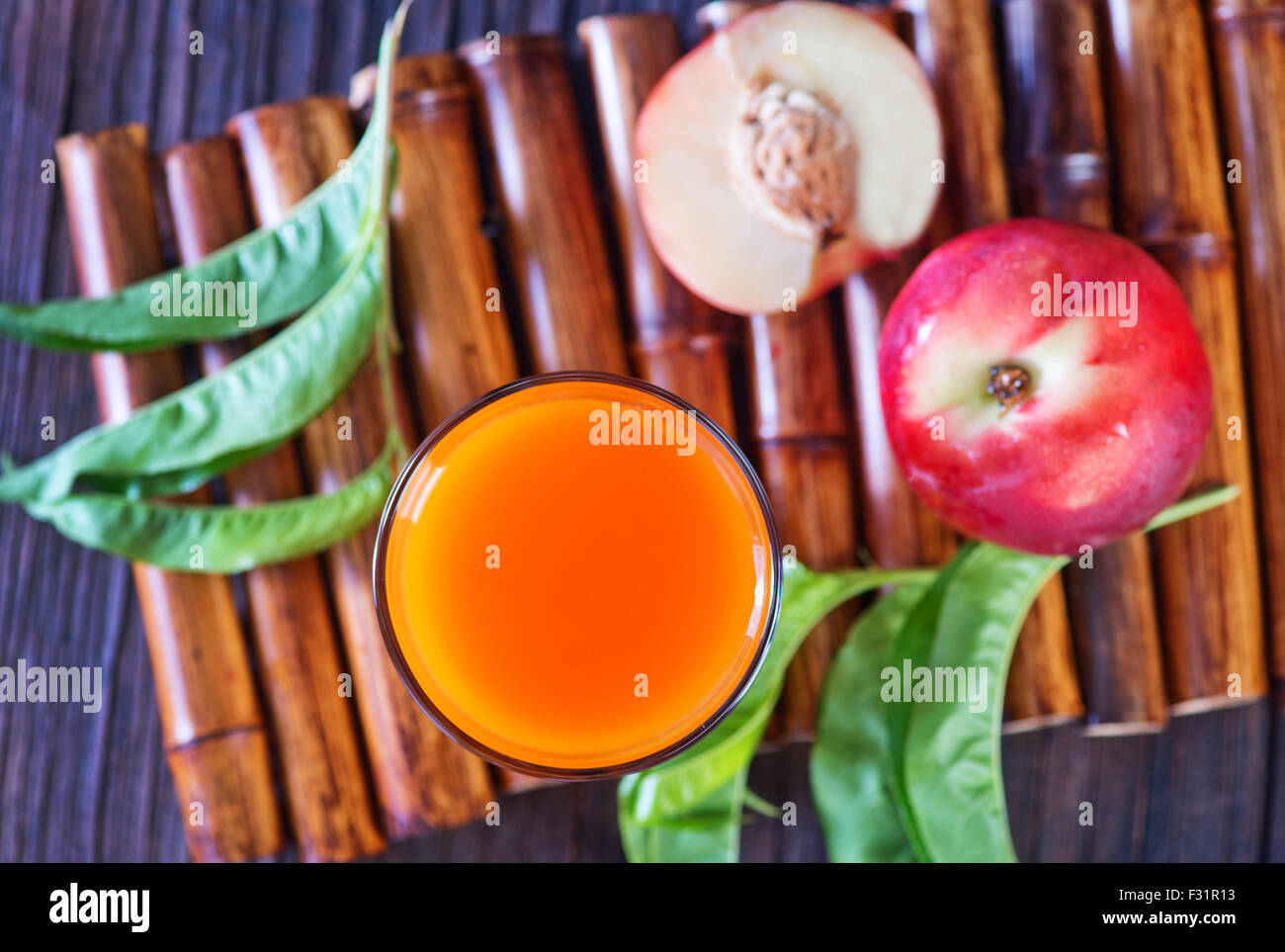nectarine juice in glass and on a table Stock Photo - Alamy