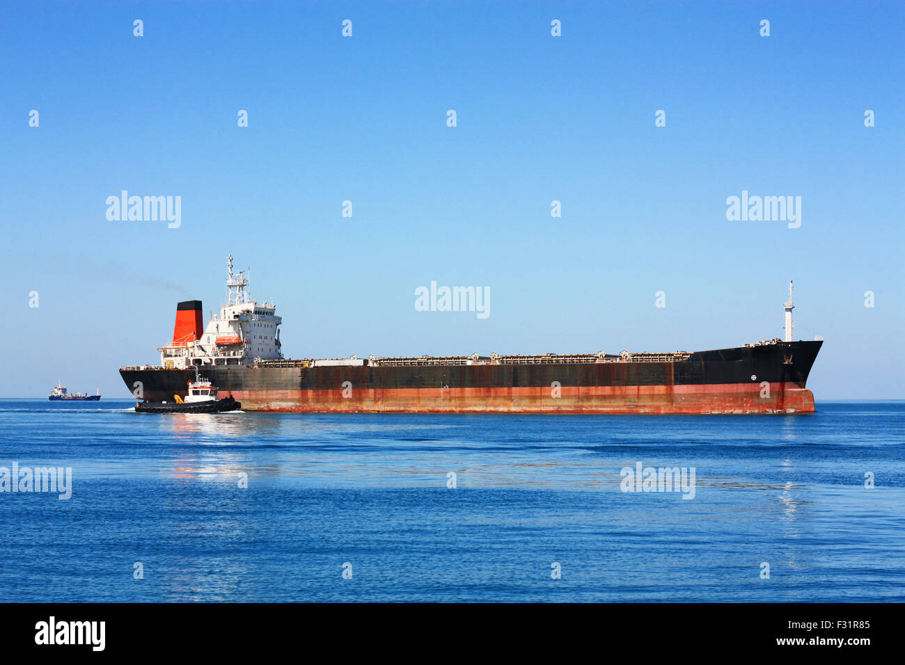 Self-propelled barge at sea in the roads waiting to enter the seaport ...