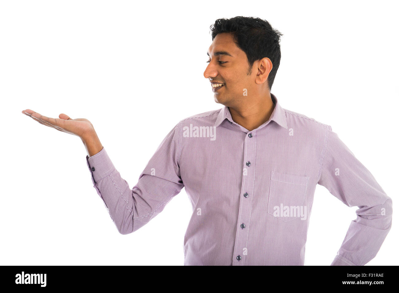 portrait of young businessman pointing at invisible product over white ...