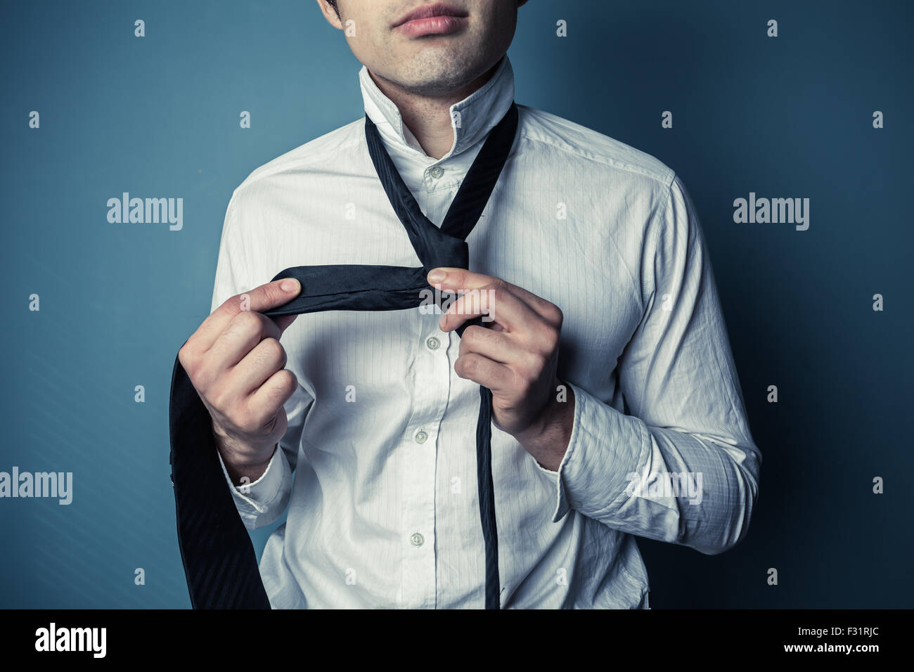 Businessman tying tie hi-res stock photography and images - Alamy