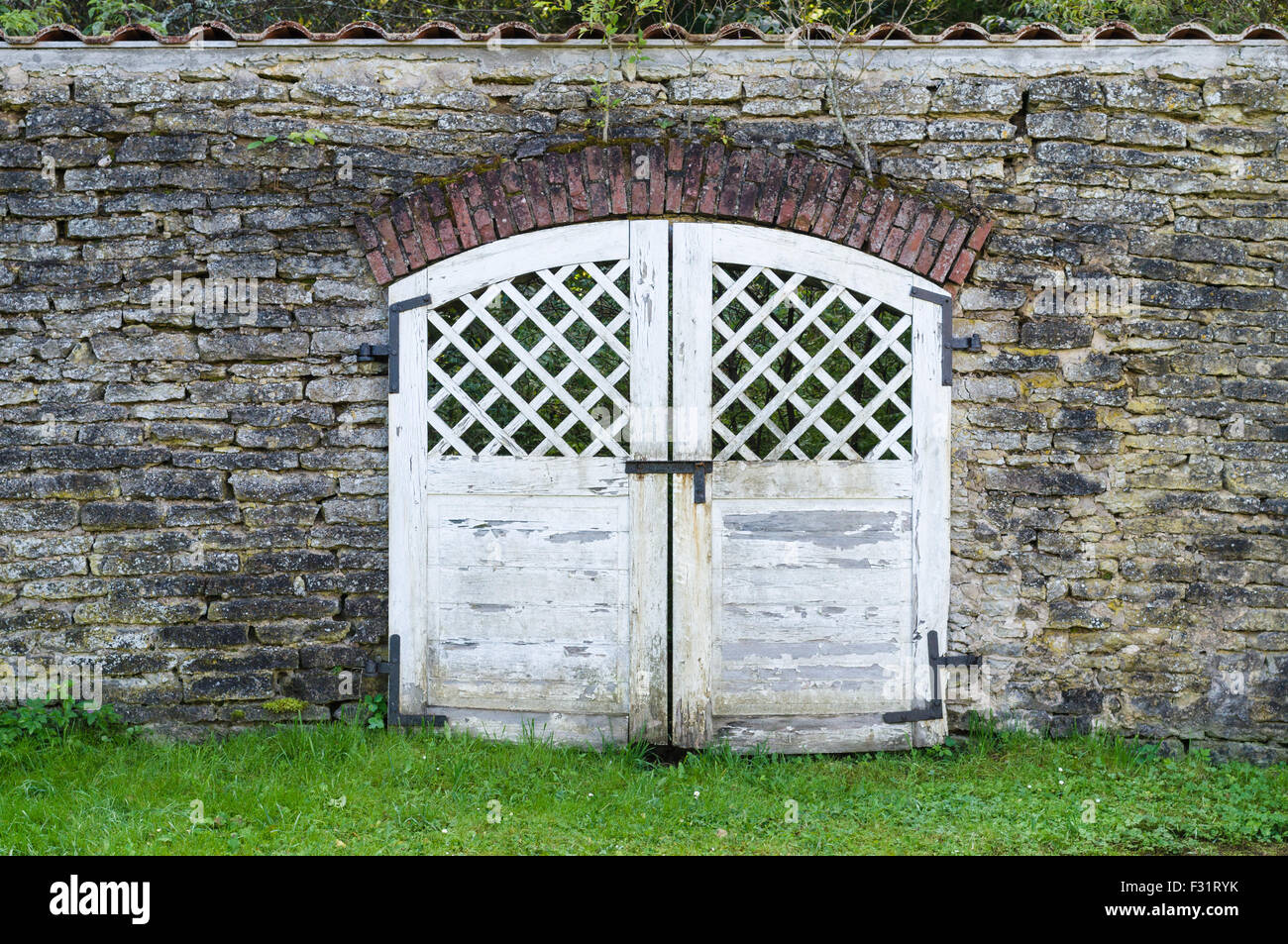 White weathered wooden gate in old limestone wall Stock Photo - Alamy