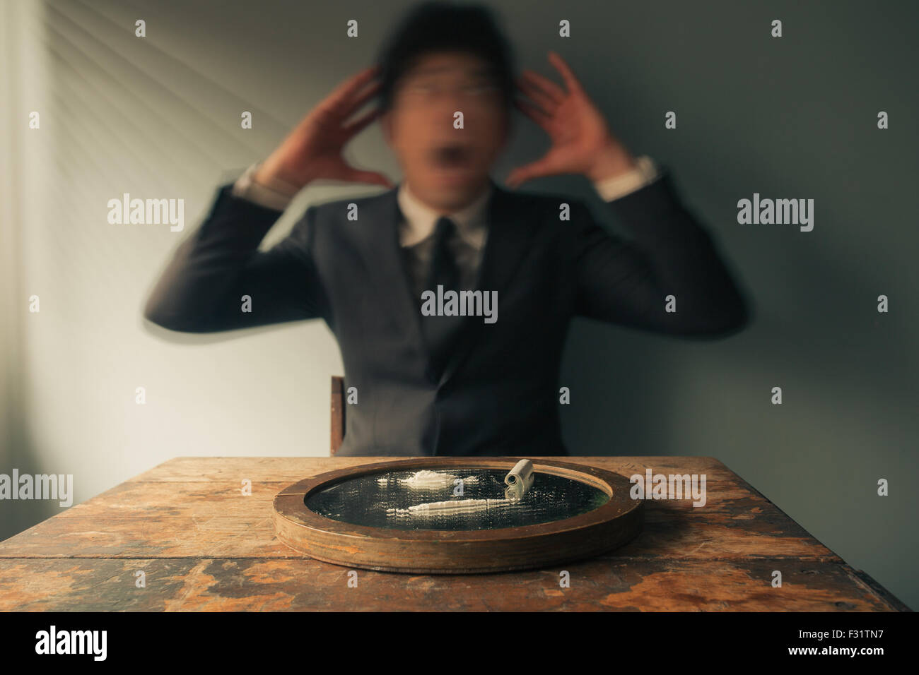 Young businessman is shaking after getting high on cocaine Stock Photo ...