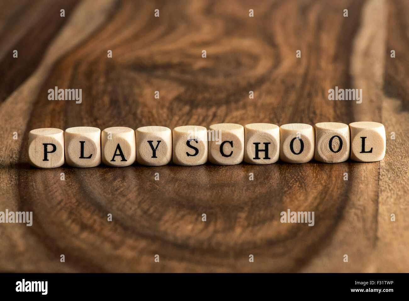 PLAYSCHOOL word background on wood blocks Stock Photo - Alamy