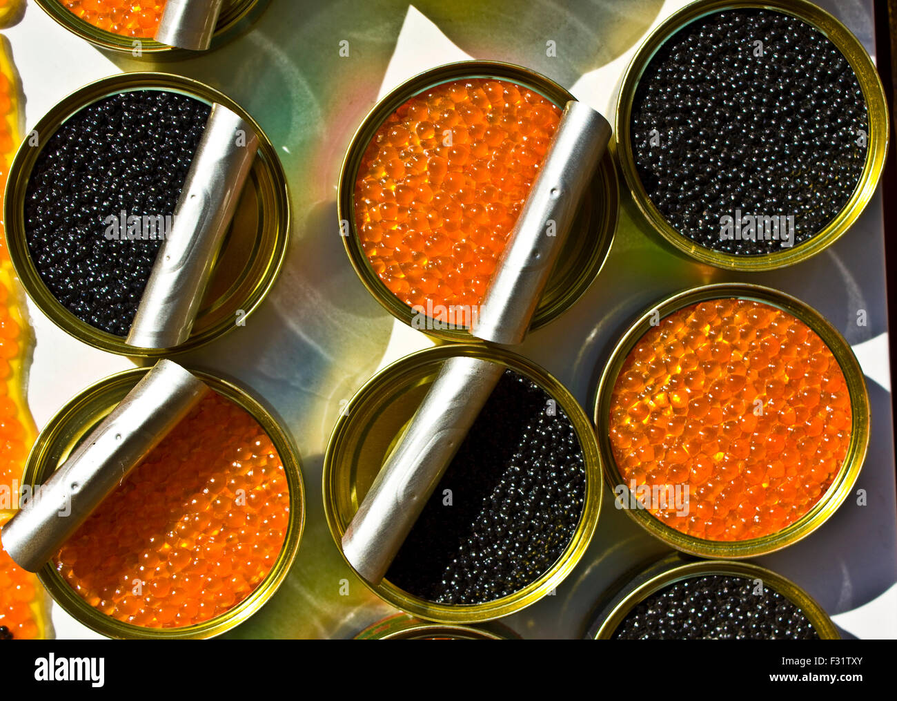 Tins (cans) with red and black caviar, opened Stock Photo - Alamy