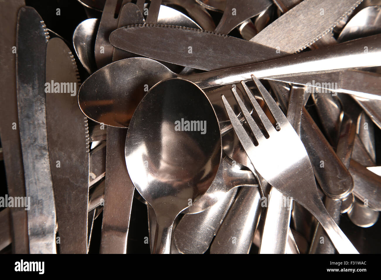 cutlery abstract background on black Stock Photo - Alamy