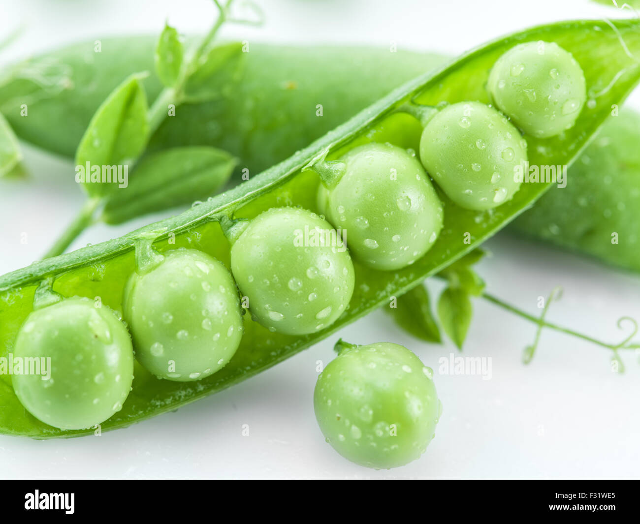 Open pea pod on a white background Stock Photo - Alamy