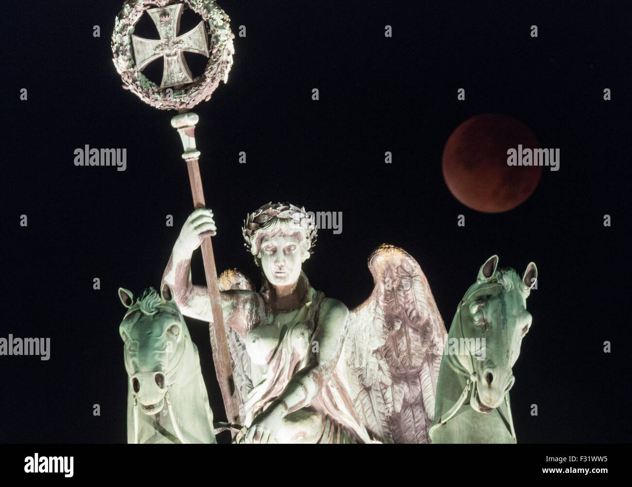 The perigee full moon, or supermoon, appears red behind the quadriga of ...