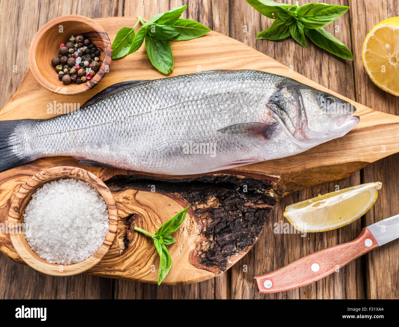 Seabass fish on the graphite board Stock Photo - Alamy