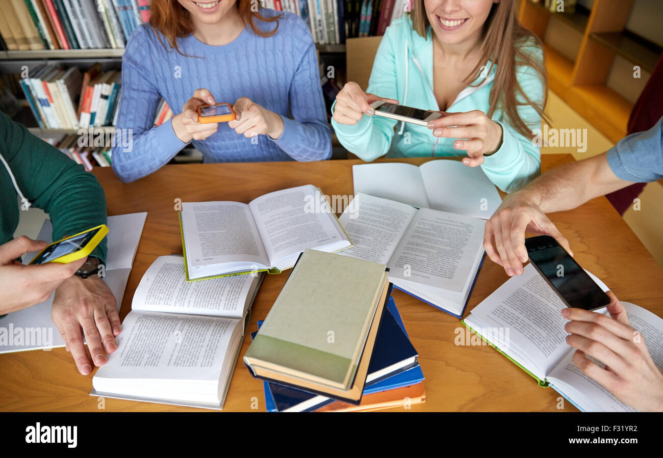 students with smartphones making cheat sheets Stock Photo - Alamy