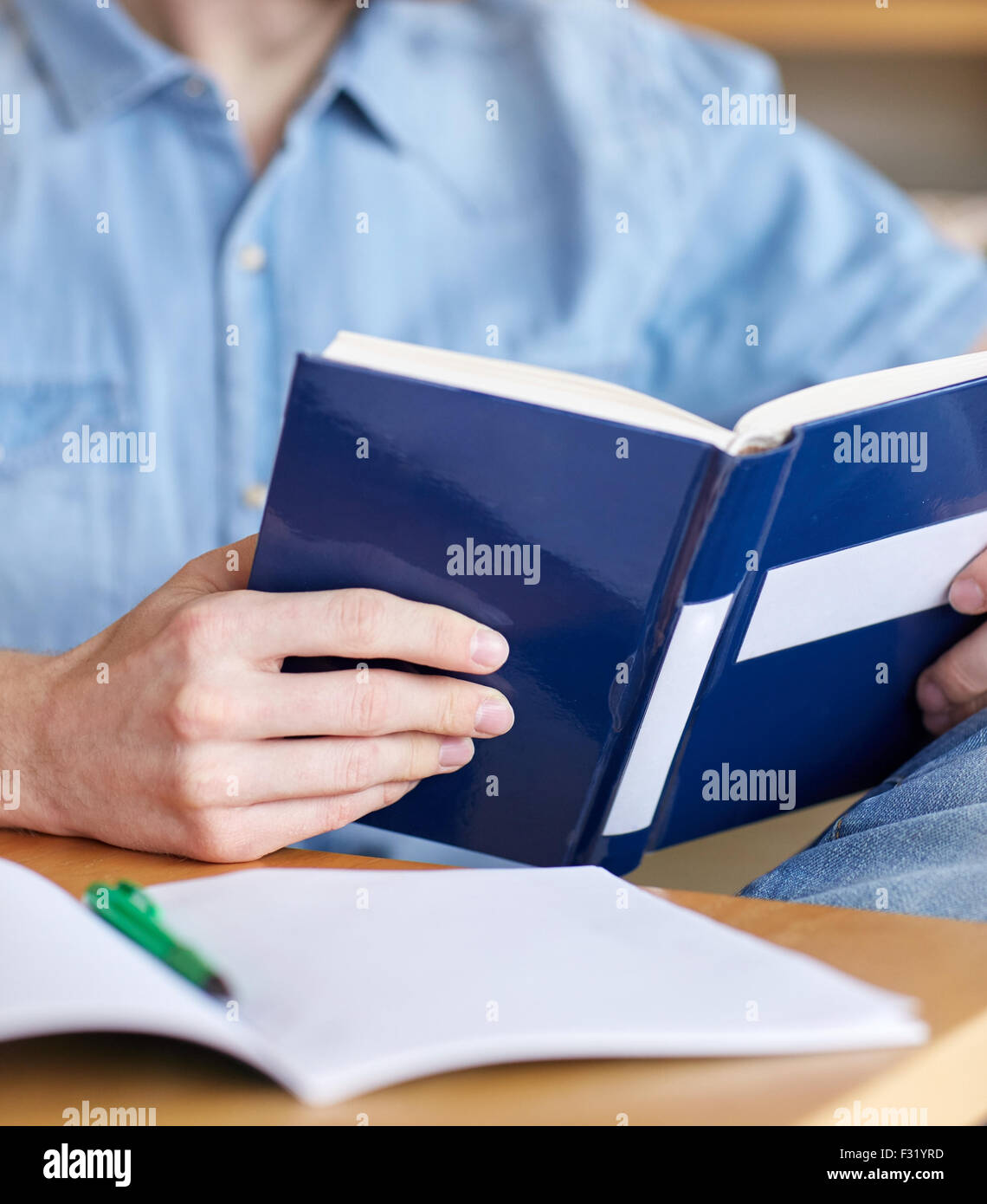 close up of student reading book at school Stock Photo - Alamy