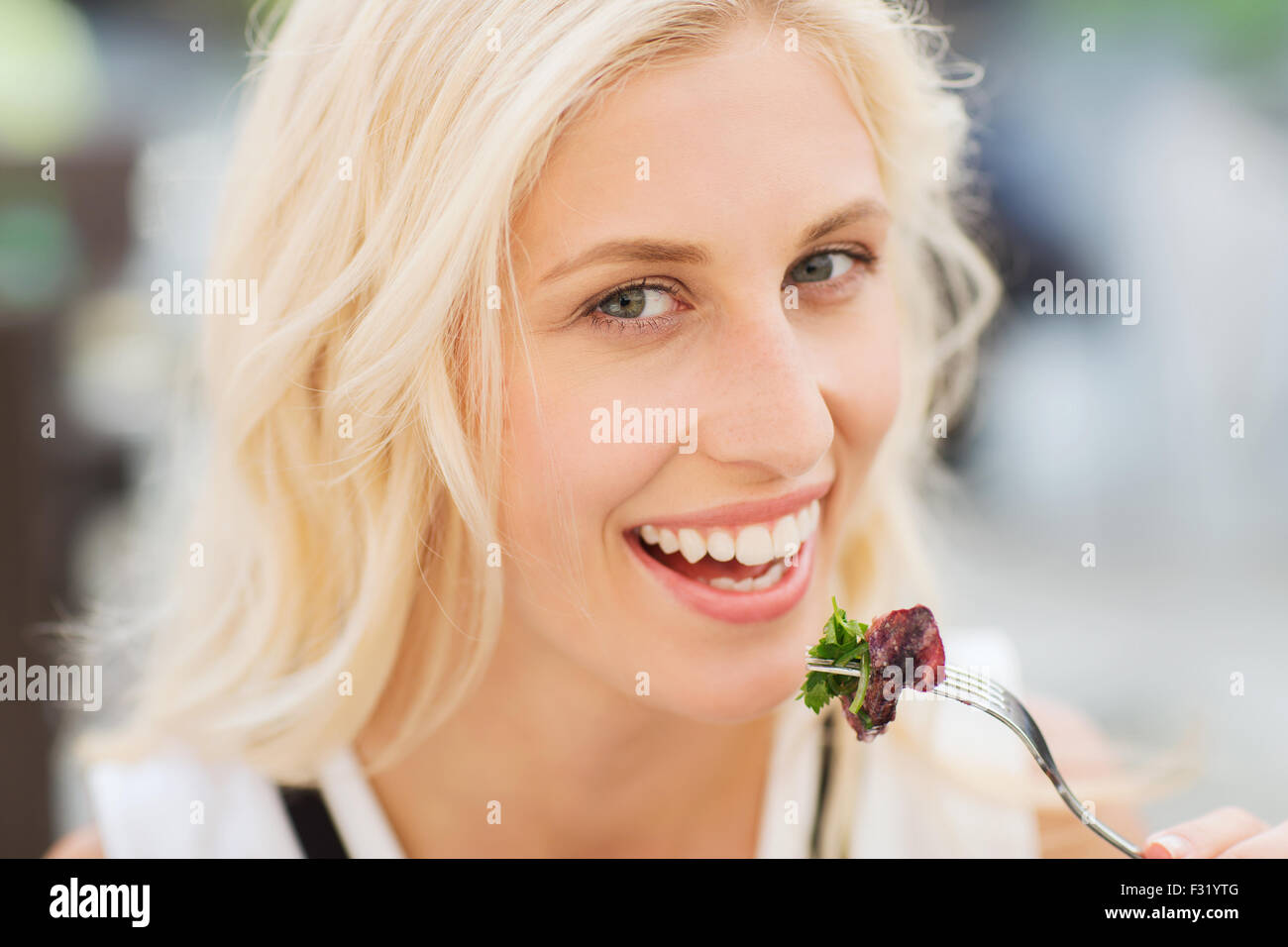 happy woman eating dinner at restaurant terrace Stock Photo - Alamy
