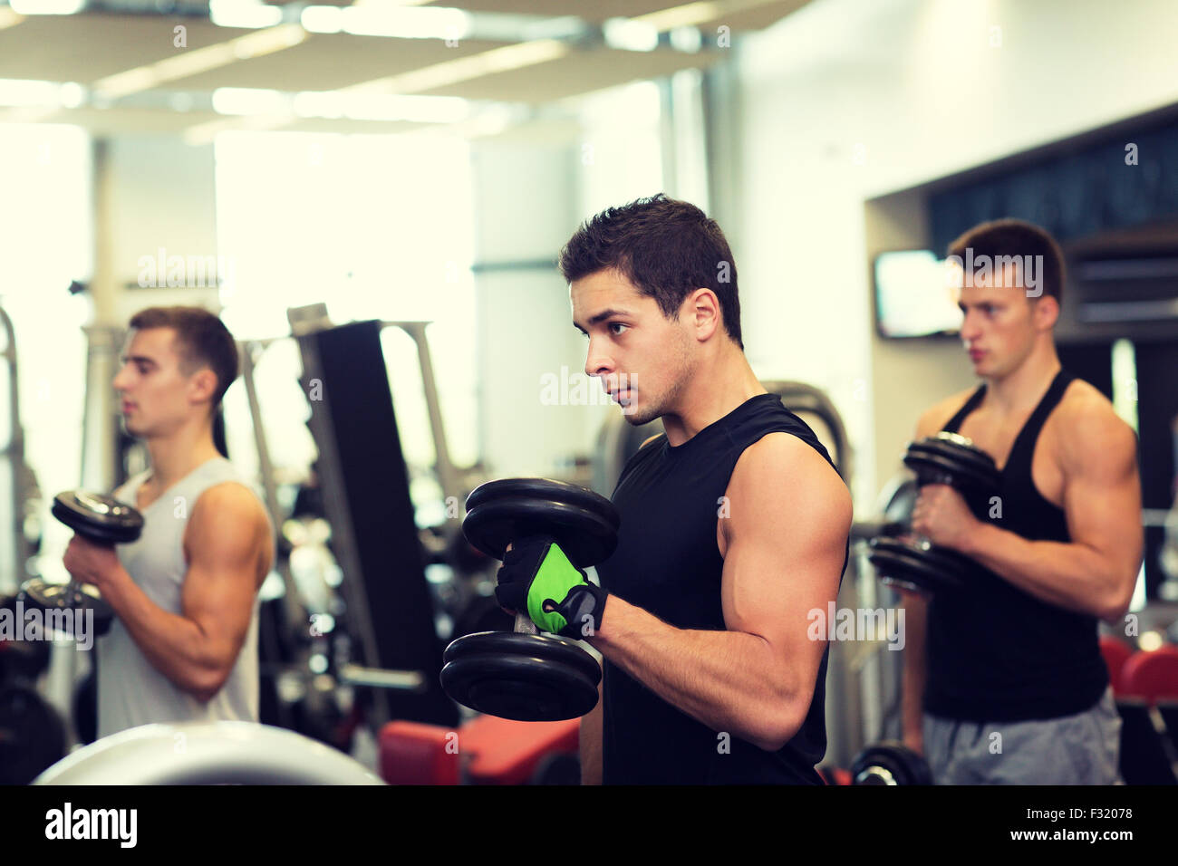 group of men with dumbbells in gym Stock Photo - Alamy
