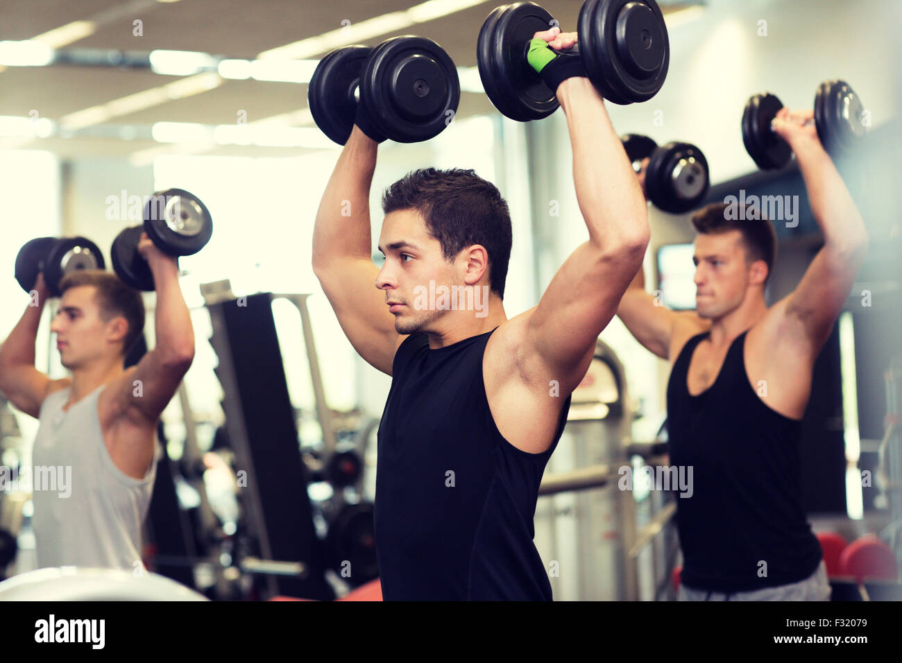 group of men with dumbbells in gym Stock Photo - Alamy