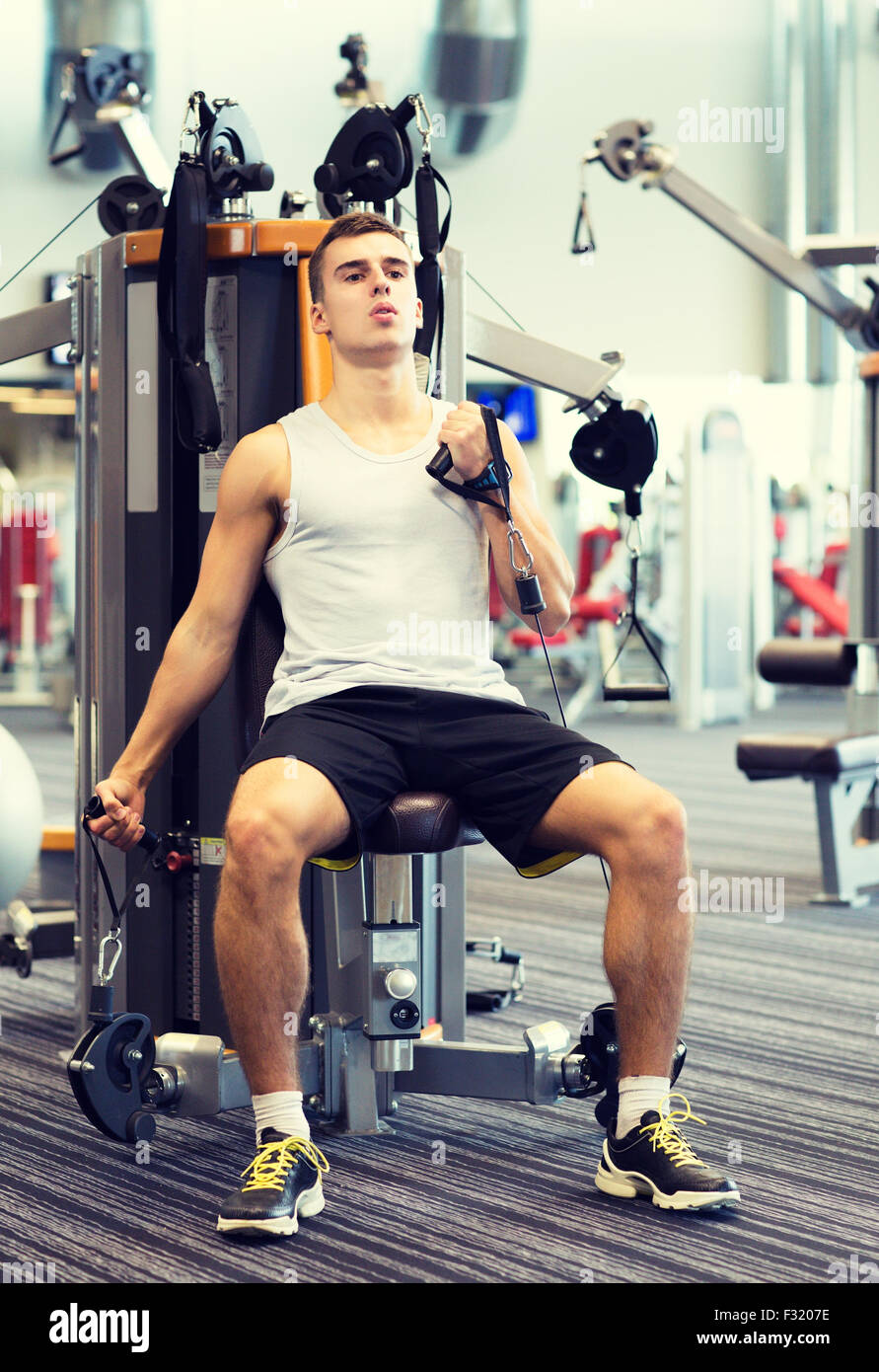 man exercising on gym machine Stock Photo - Alamy