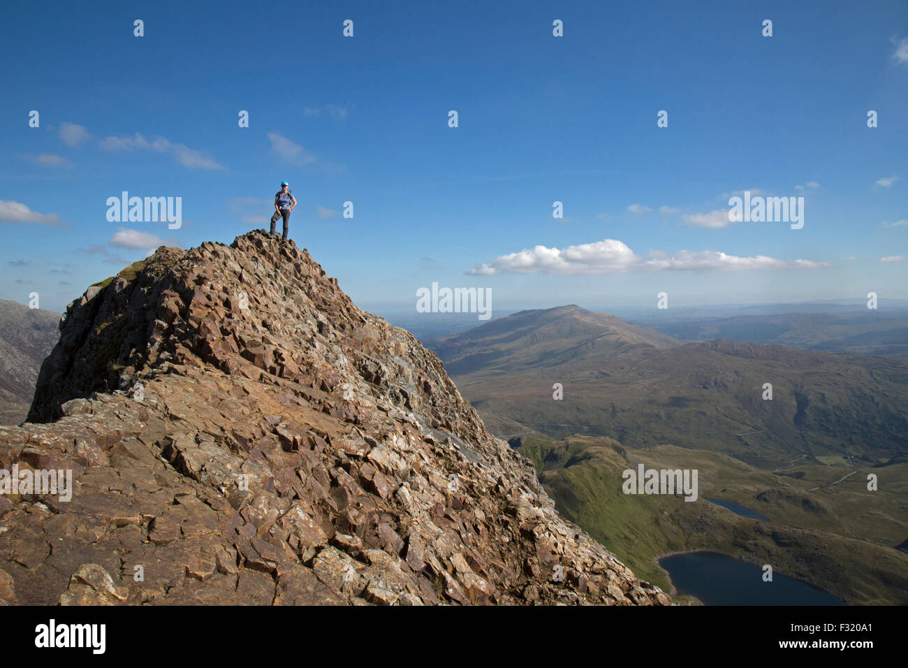 A lone female hiker on Crib Goch (Red Ridge) in Snowdonia, North wales ...