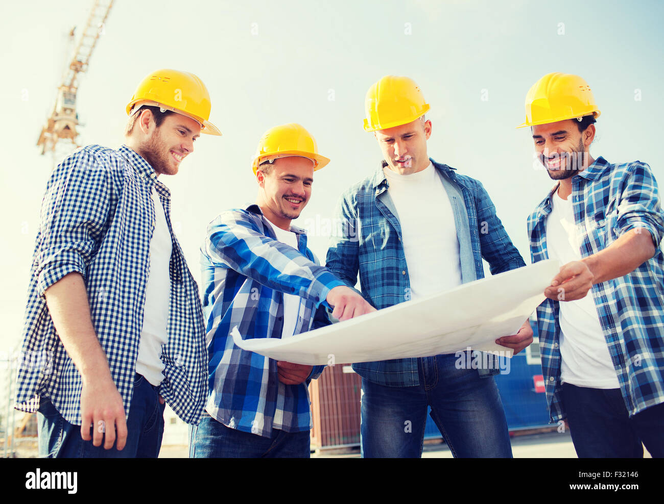 group of builders with tablet pc and blueprint Stock Photo - Alamy