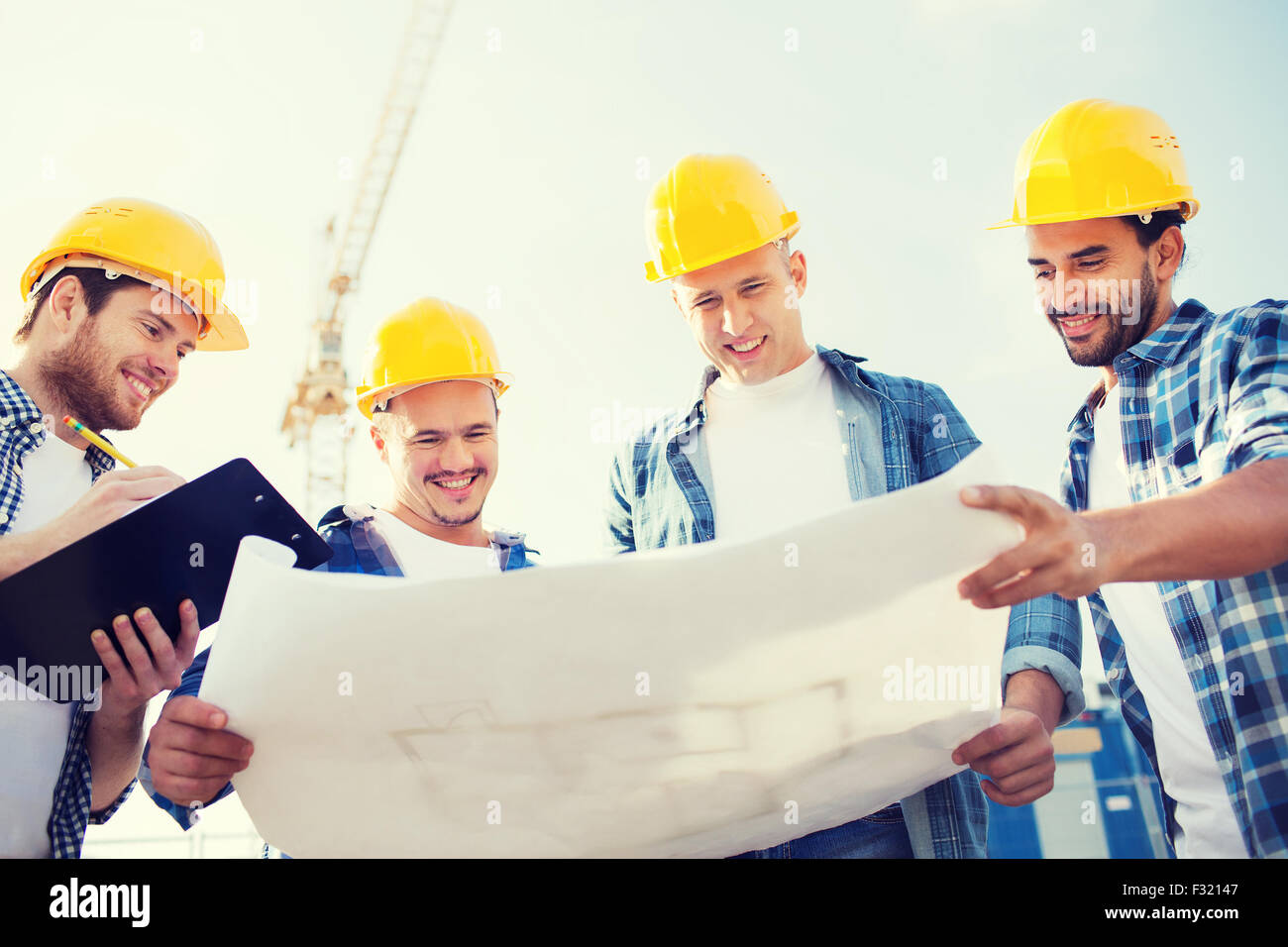group of builders with tablet pc and blueprint Stock Photo - Alamy