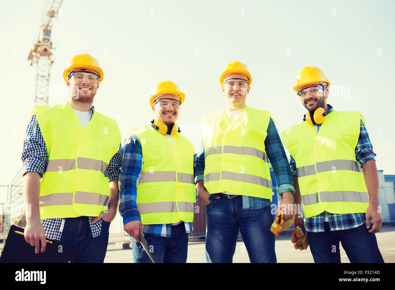 group of smiling builders with tablet pc outdoors Stock Photo - Alamy