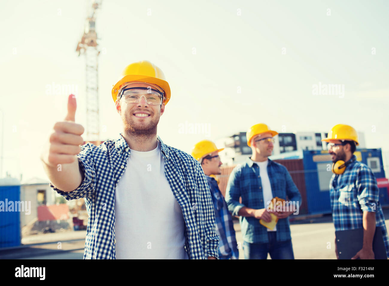 group of smiling builders in hardhats outdoors Stock Photo - Alamy