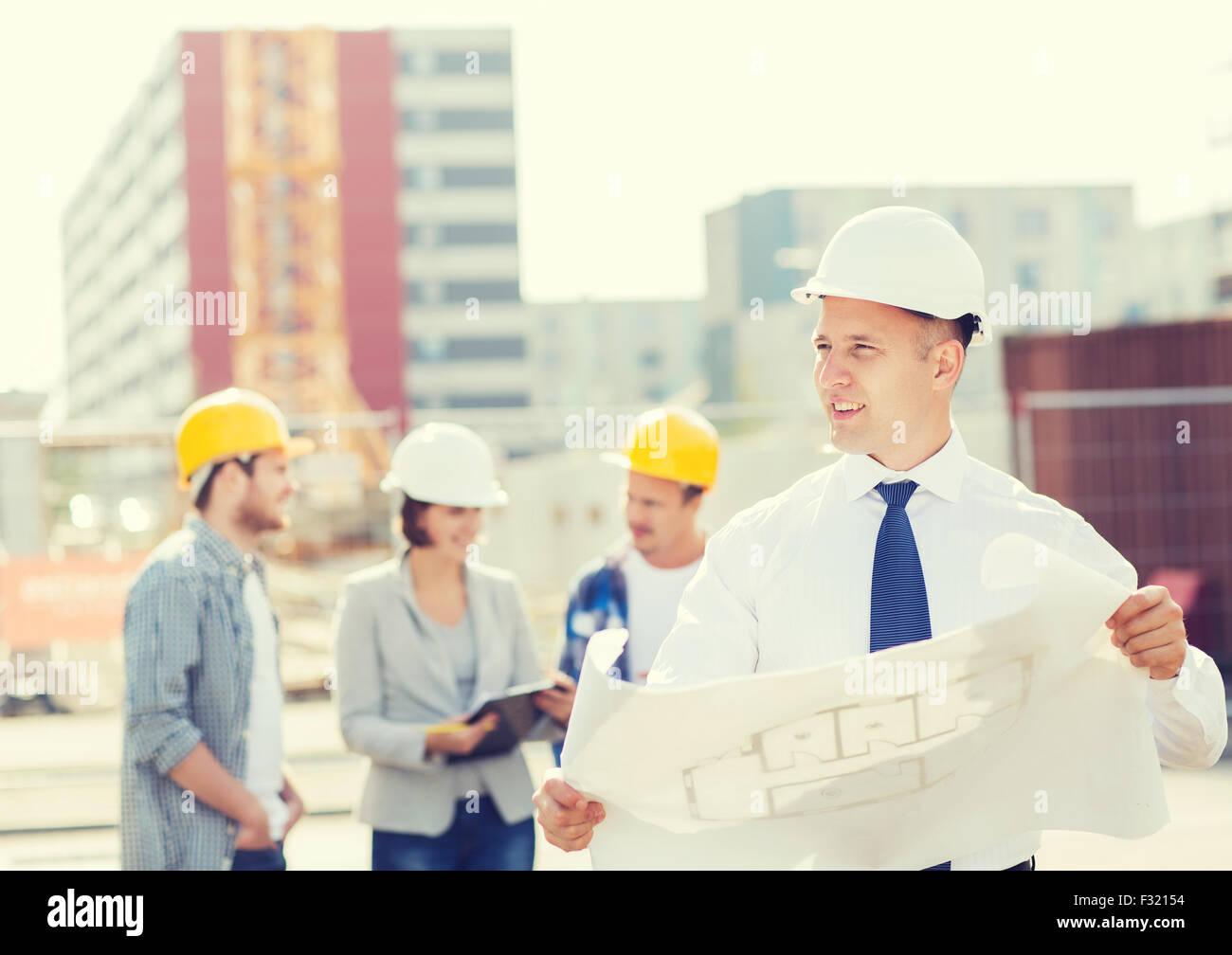 group of builders with tablet pc and blueprint Stock Photo - Alamy