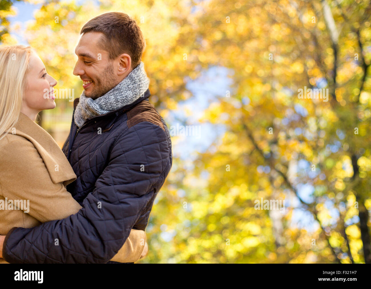 smiling couple hugging over autumn background Stock Photo - Alamy